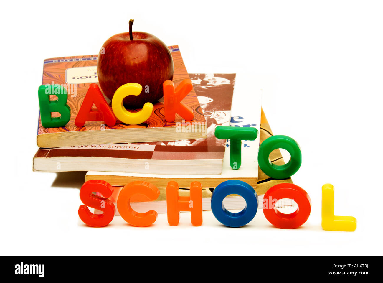 School books with red apple and Children's magnetic board spelling the ...