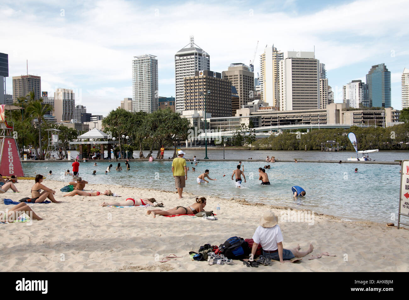 People swimming and sunbathing in summer on artificial Streets beach on ...