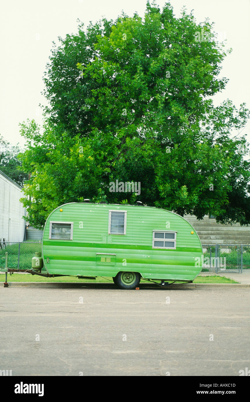 Vintage trailer parked in front of tree Stock Photo - Alamy