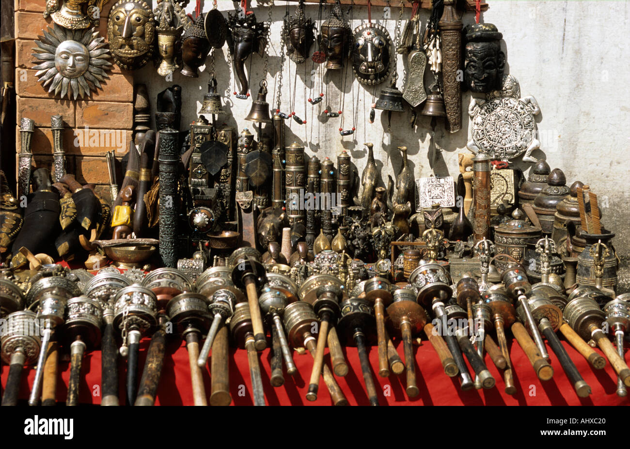 Buddhist prayer wheels and ritual items at a merchandise stand near ...