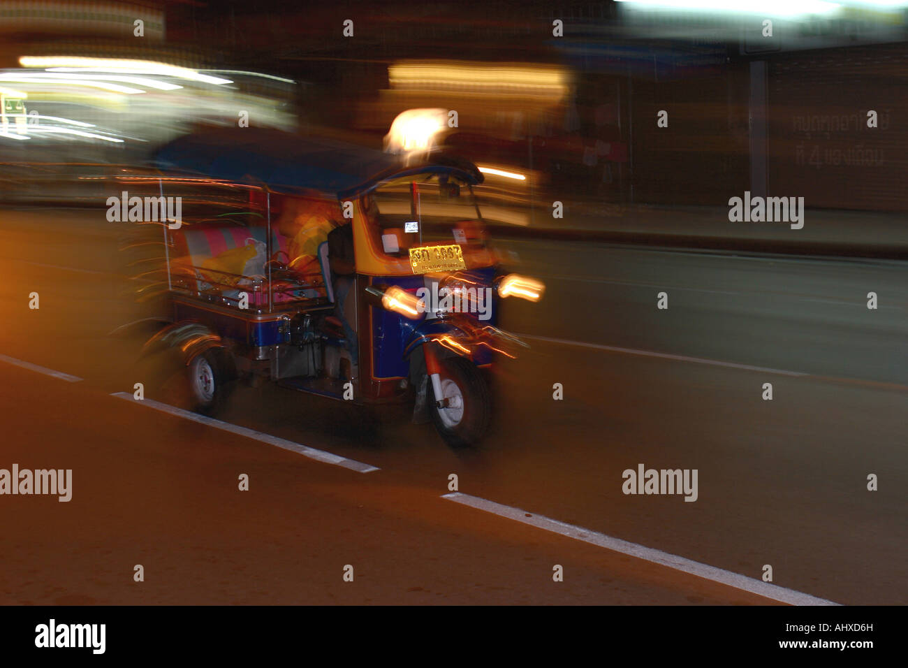 A Tuk Tuk speeds along at night in Bangkok Thailand Stock Photo - Alamy