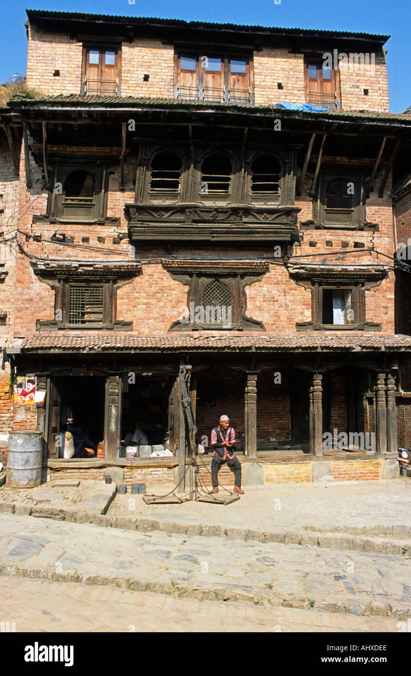 Nepali man sitting behind his traditional Newari style house Kathmandu ...