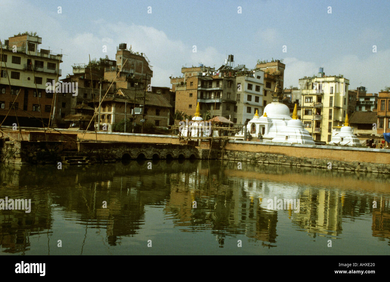 Scenic view of a white stupa reflected in a water pool in Bhaktapur ...