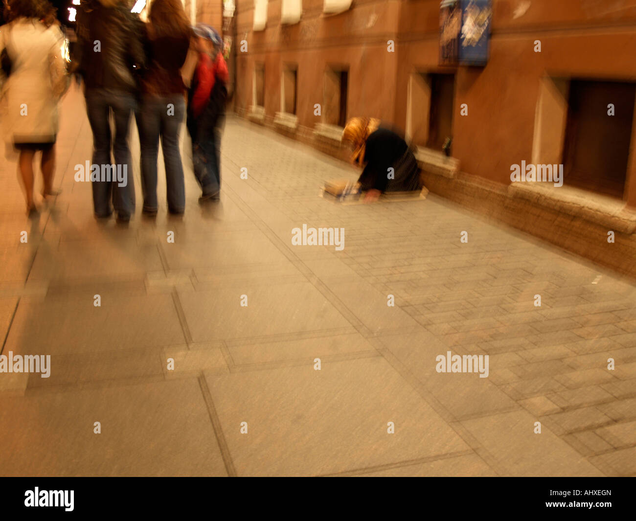 homeless person beggar on pavement in the evening in the city of Saint ...