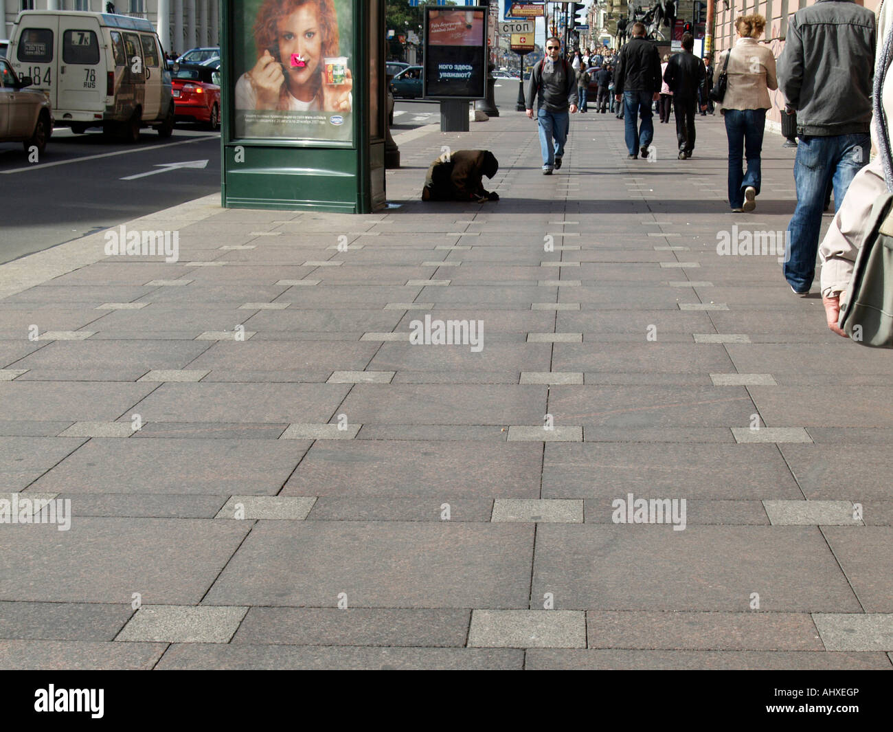 homeless person beggar on pavement on the Nevsky Prospekt in the city ...