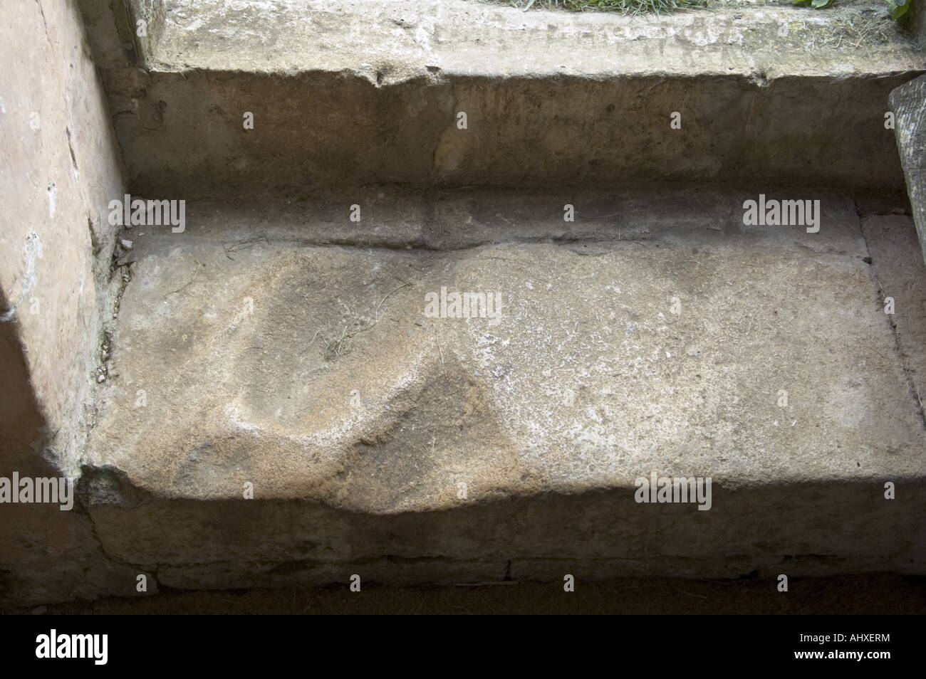 Worn stone step of the entrance to 13 century medieval church of St ...
