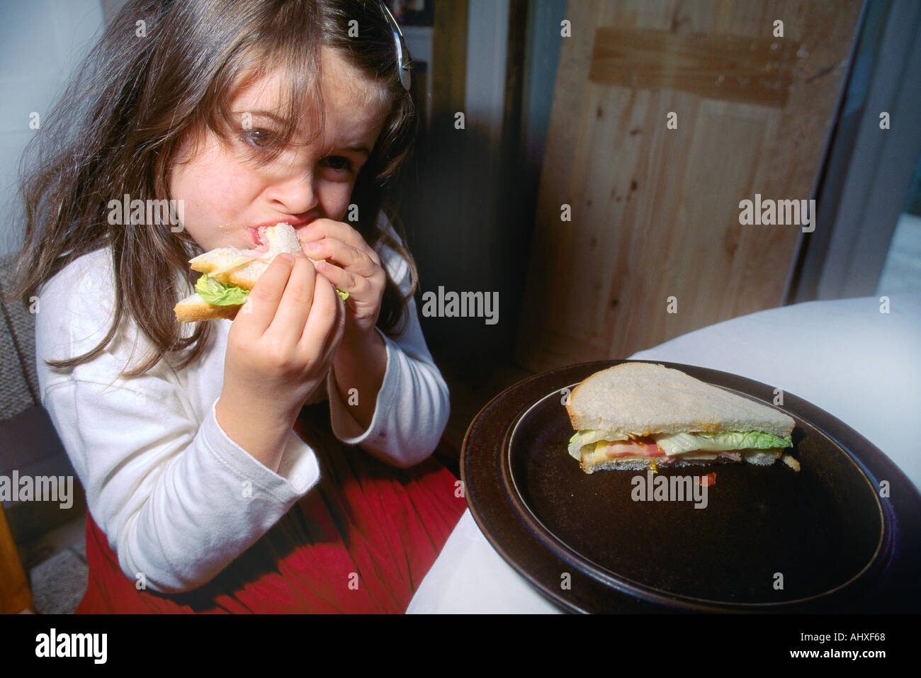 Child Eating Ham And Cheese Salad Sandwich Stock Photo - Alamy