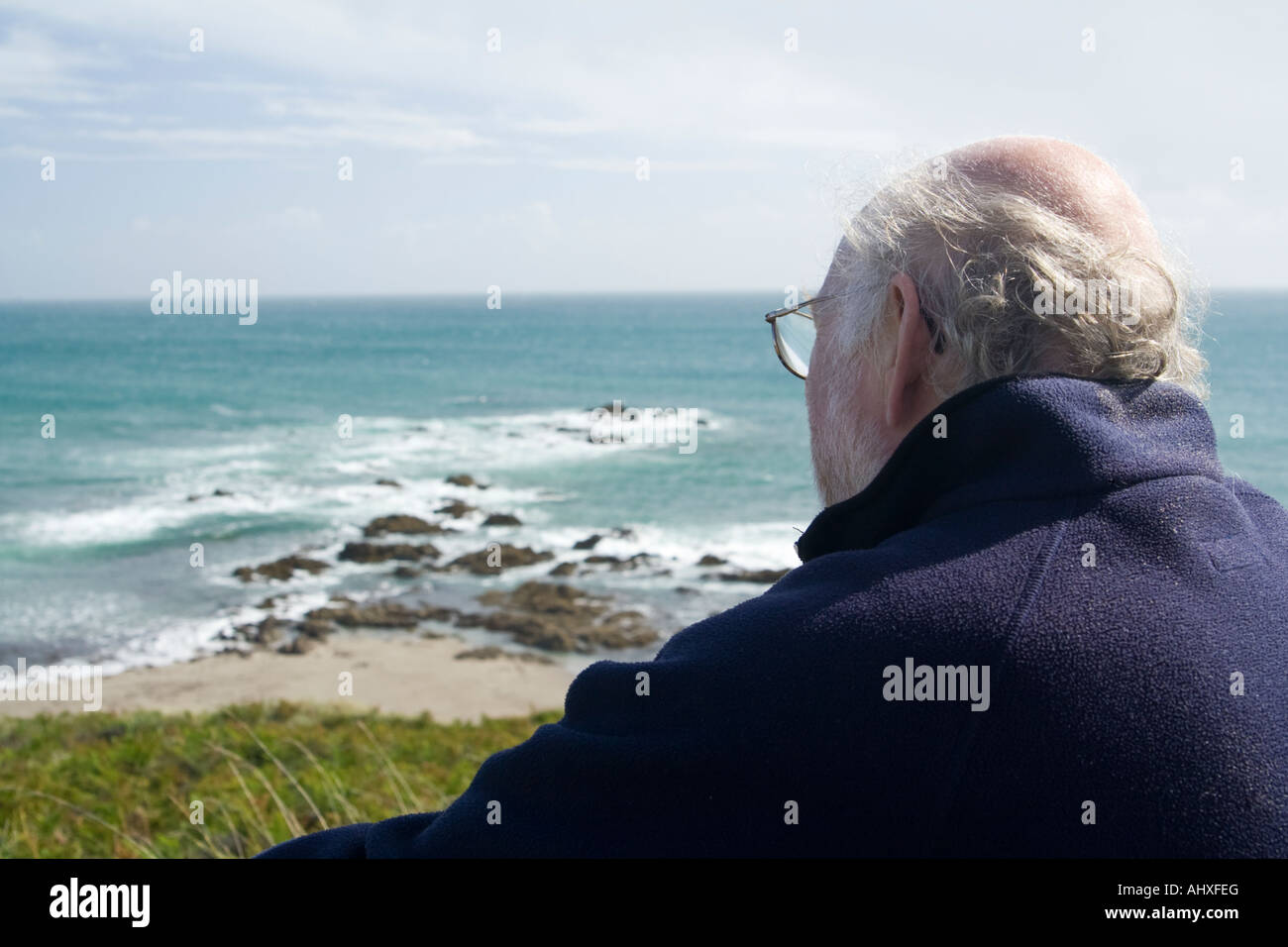 Man looking out to sea Stock Photo - Alamy