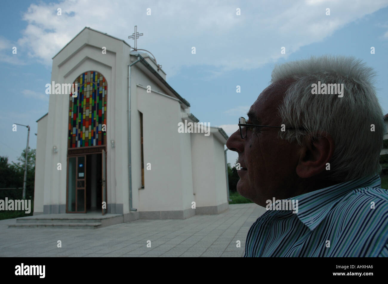 A 56 years old man in front of a new built orthodoxy chapel in the ...