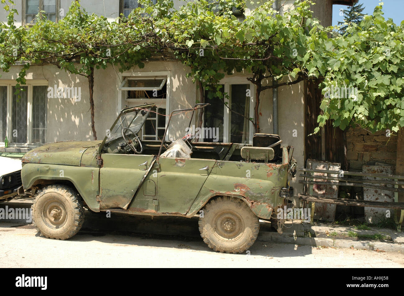 Old Russian Soviet rover vehicle in front of a Bulgarian house in the ...