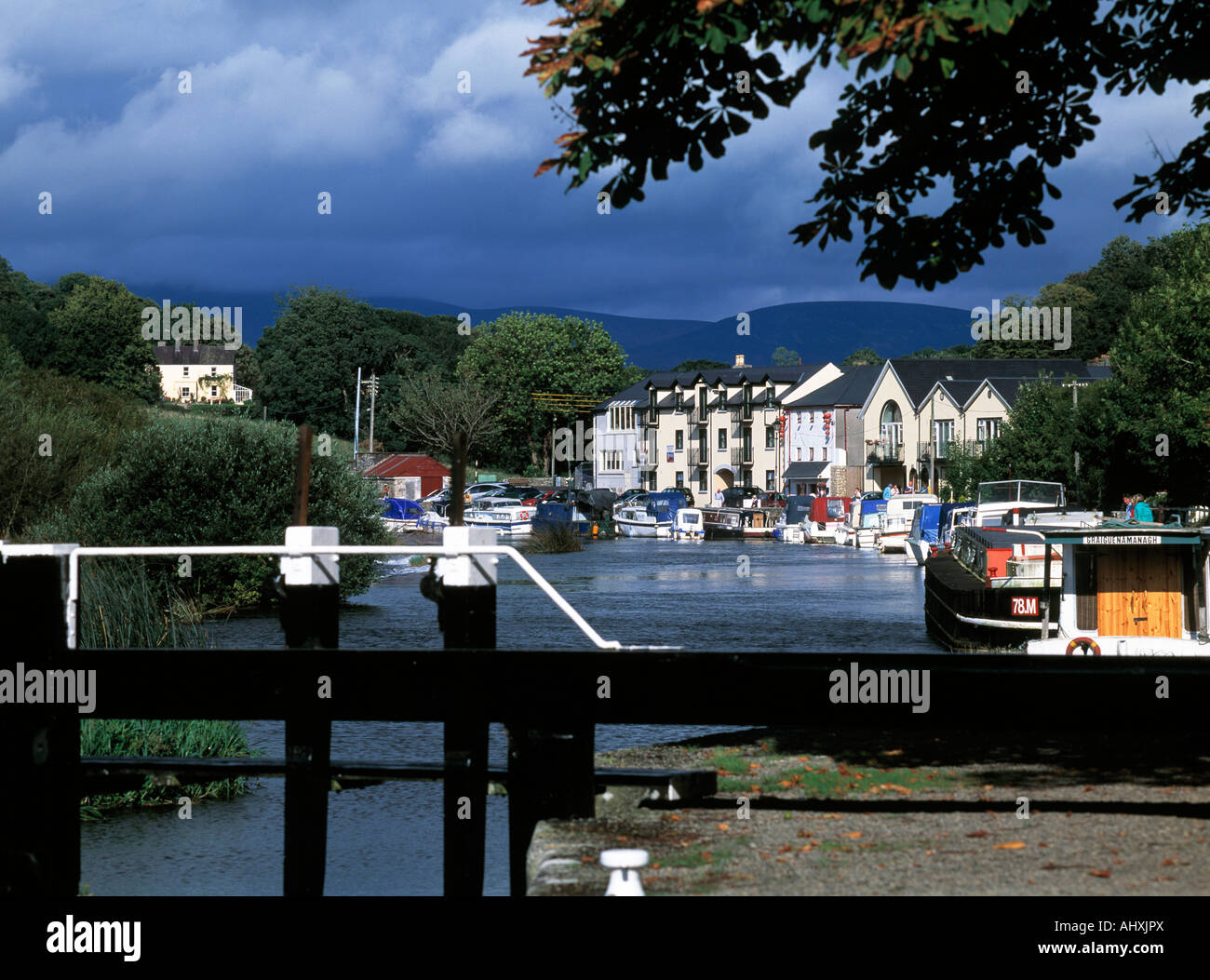 irish inland waterway with canal boats tied along the river bank Stock ...