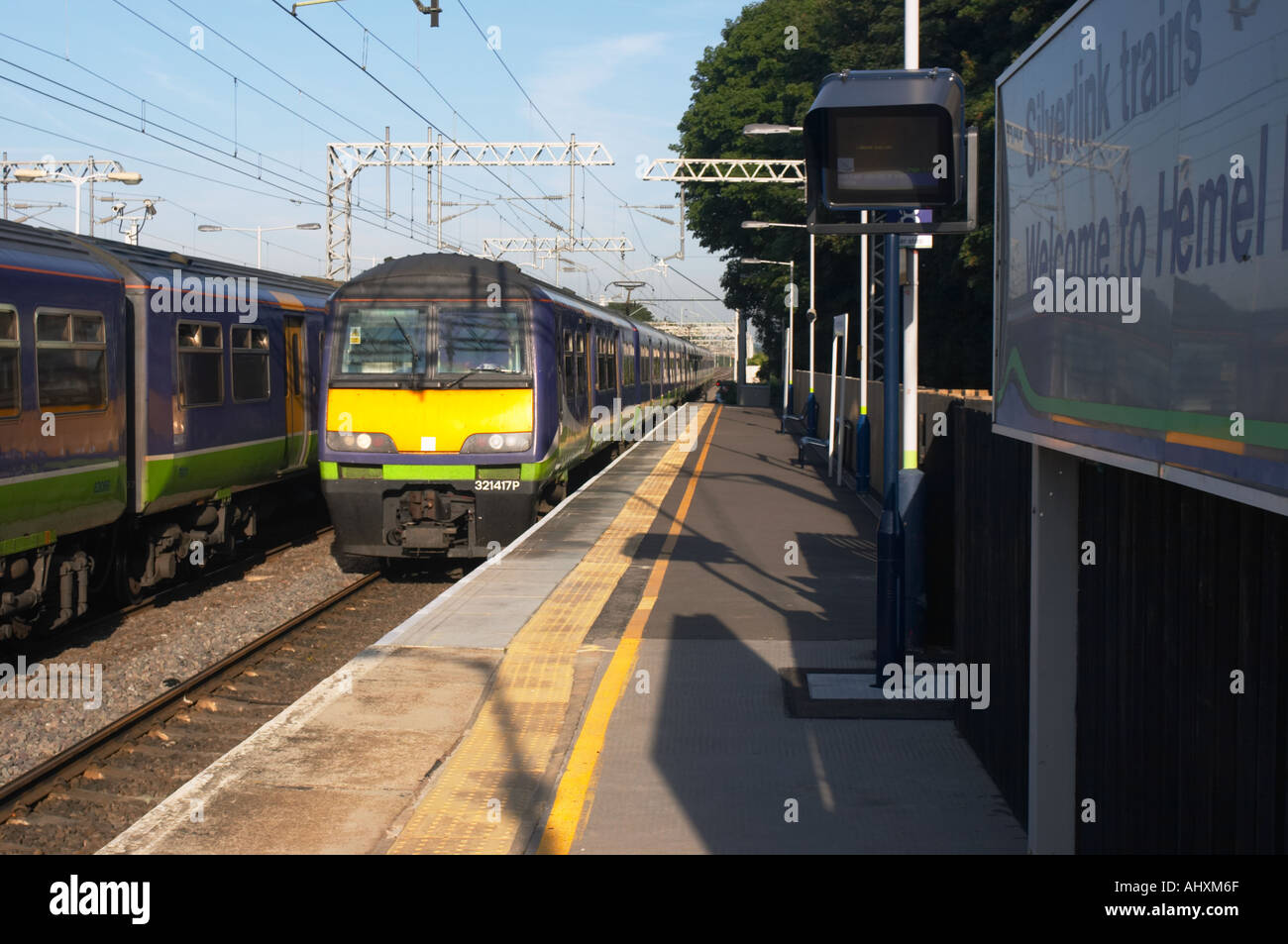 National rail Train approaching railway station Stock Photo - Alamy