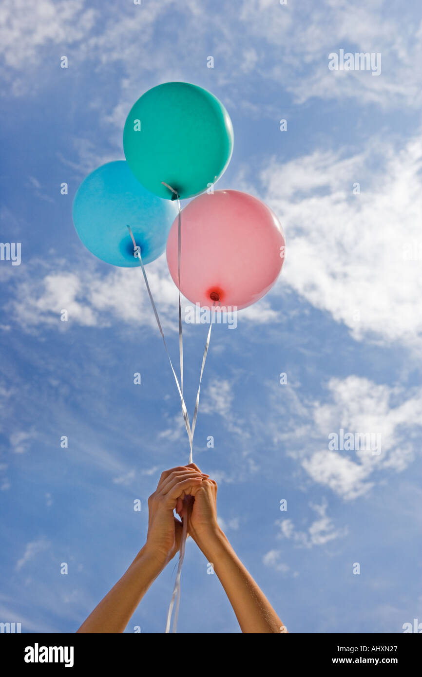 Hands holding balloons toward sky Stock Photo: 4754726 - Alamy