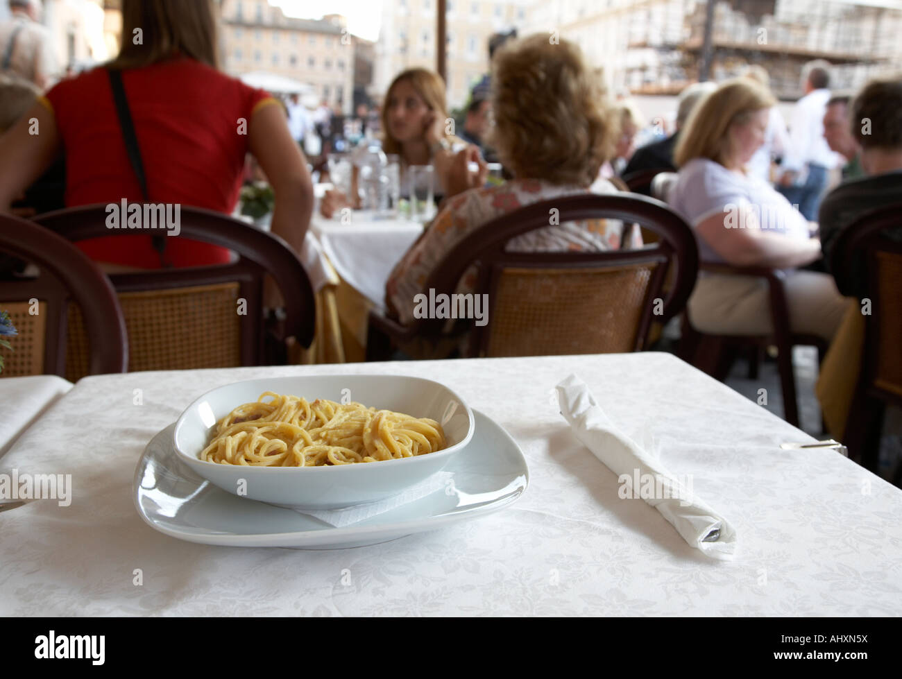 Bowl of Spaghetti Carbonara sitting on a table in a street cafe in the ...