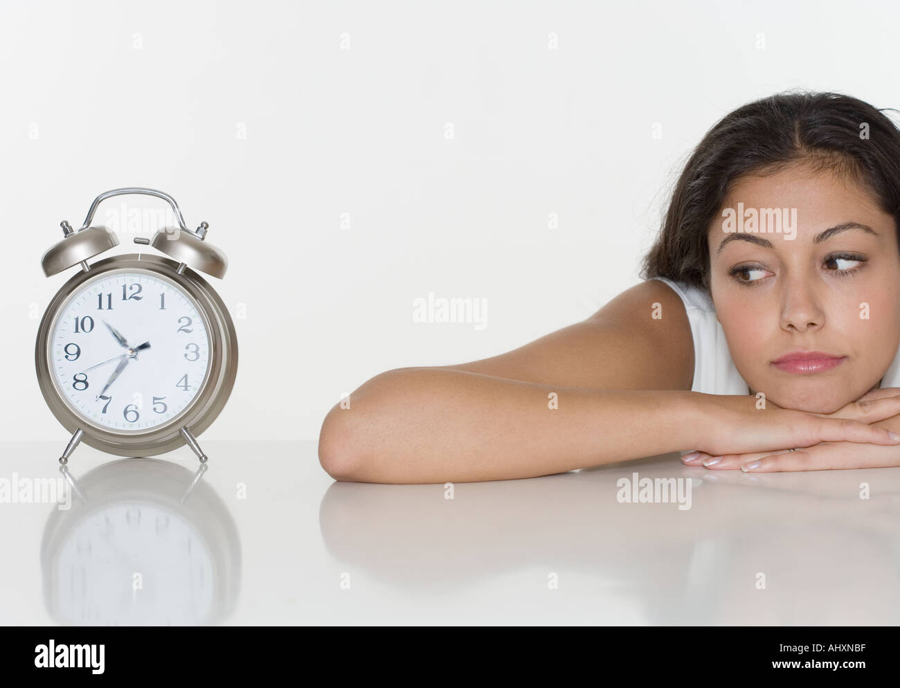 Young woman with an old fashioned alarm clock hi-res stock photography ...