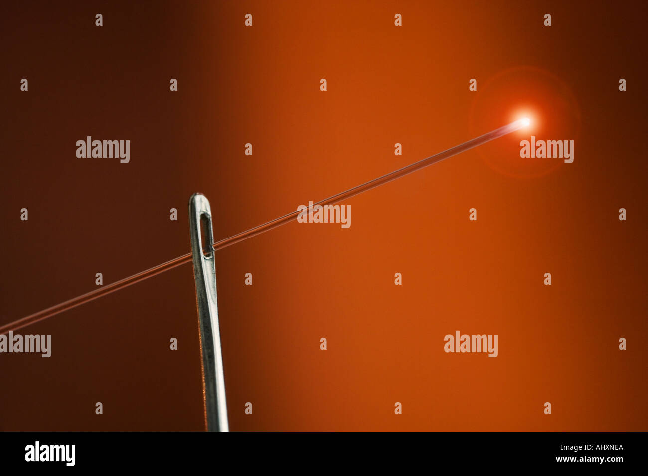 Glowing fiber optic thread with needle Stock Photo - Alamy