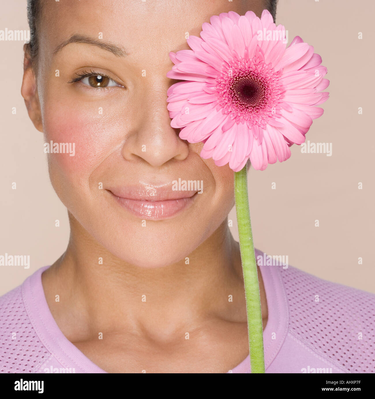 Woman with flower over one eye Stock Photo - Alamy