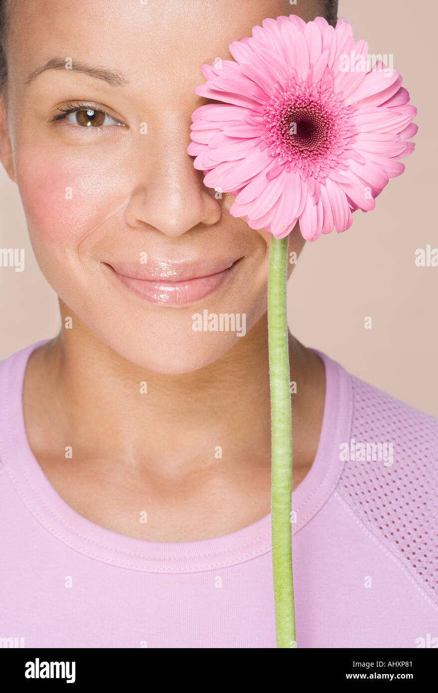 Woman with flower over one eye Stock Photo - Alamy