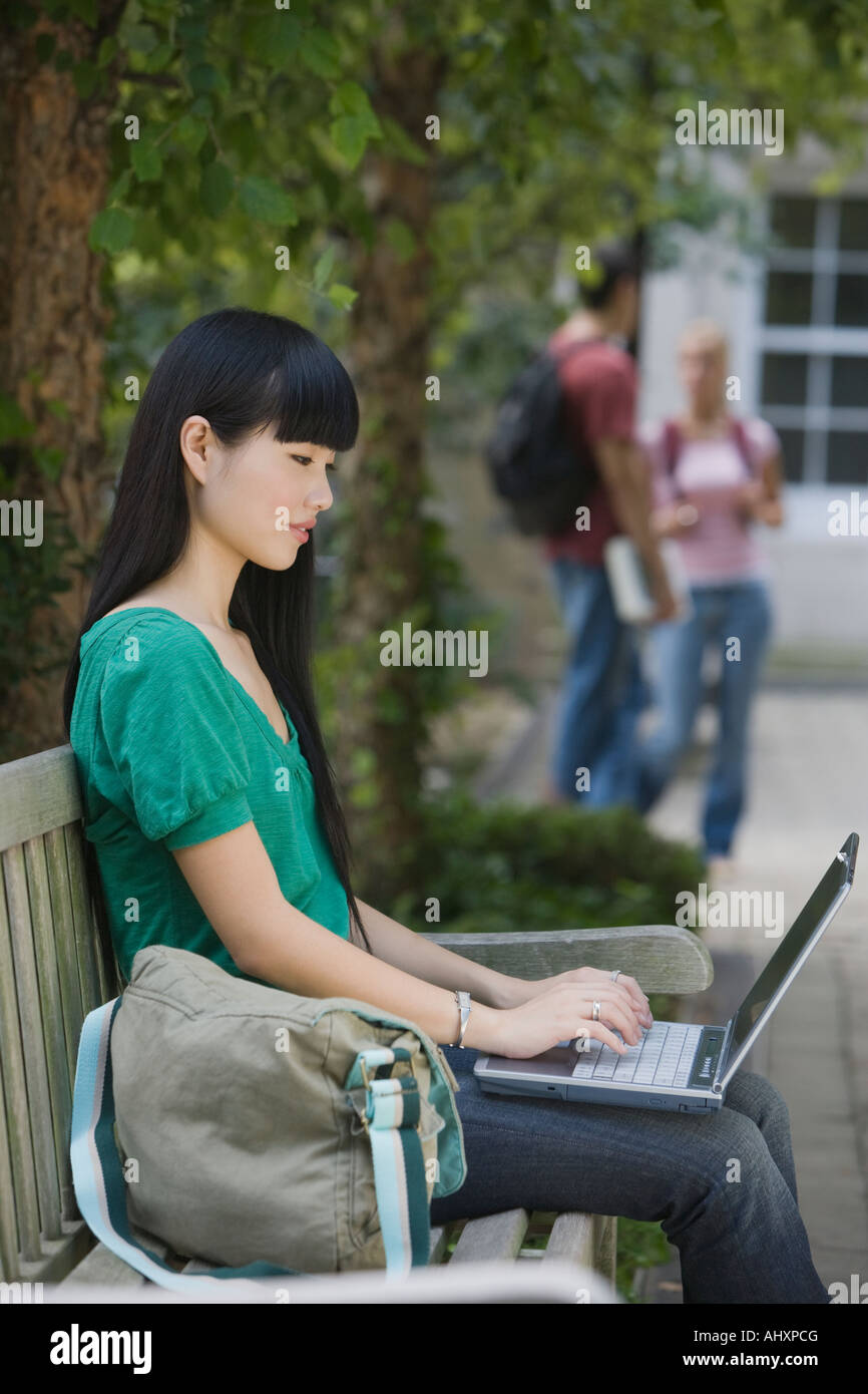 Female college student typing on laptop Stock Photo - Alamy