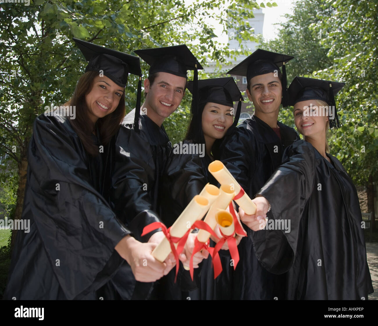 Female college graduates holding diplomas Stock Photo - Alamy