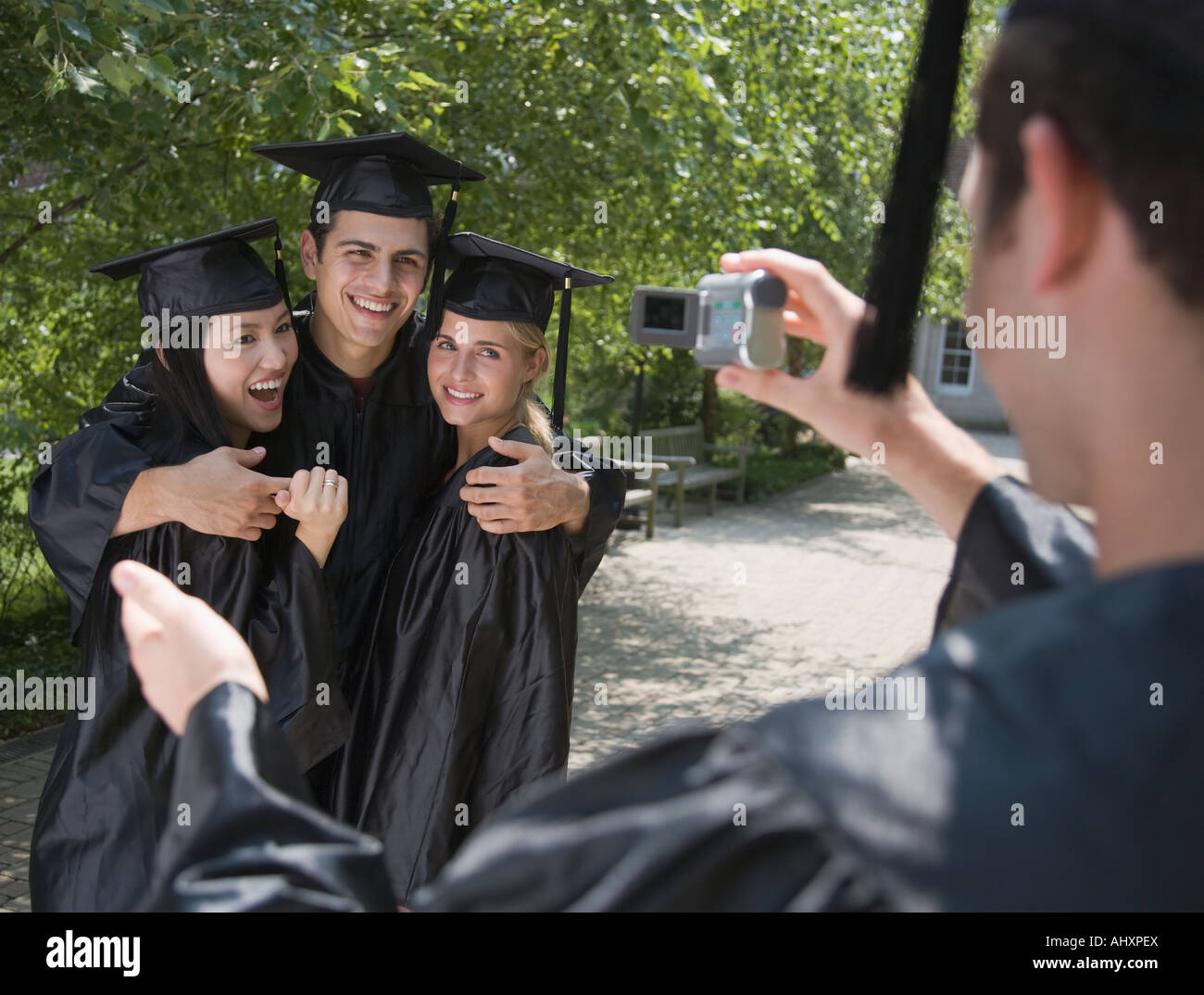 Female college graduates taking own photograph Stock Photo - Alamy