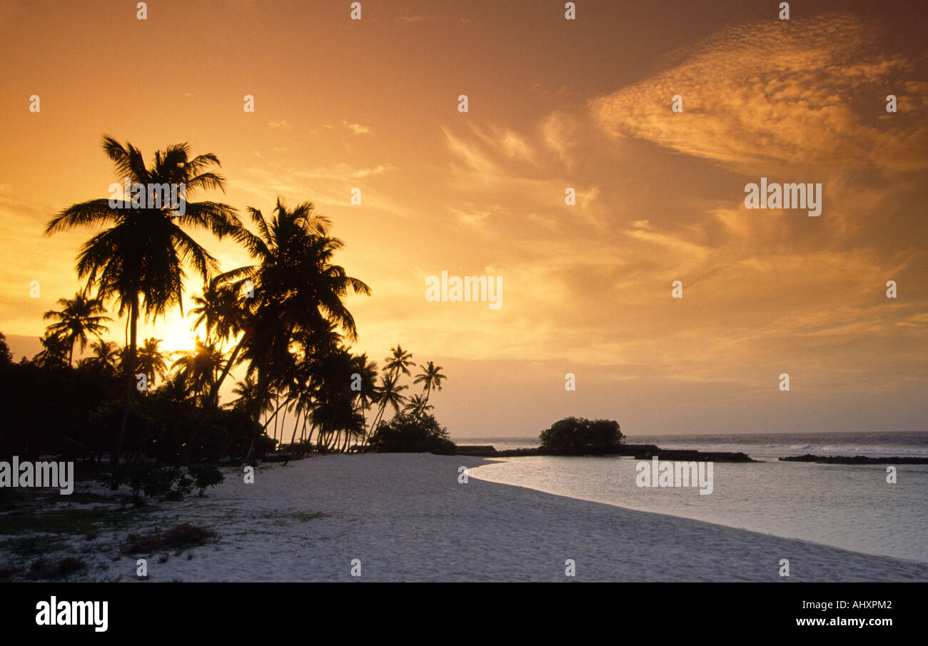 Maldives sun setting over white sand tropical beach Stock Photo - Alamy