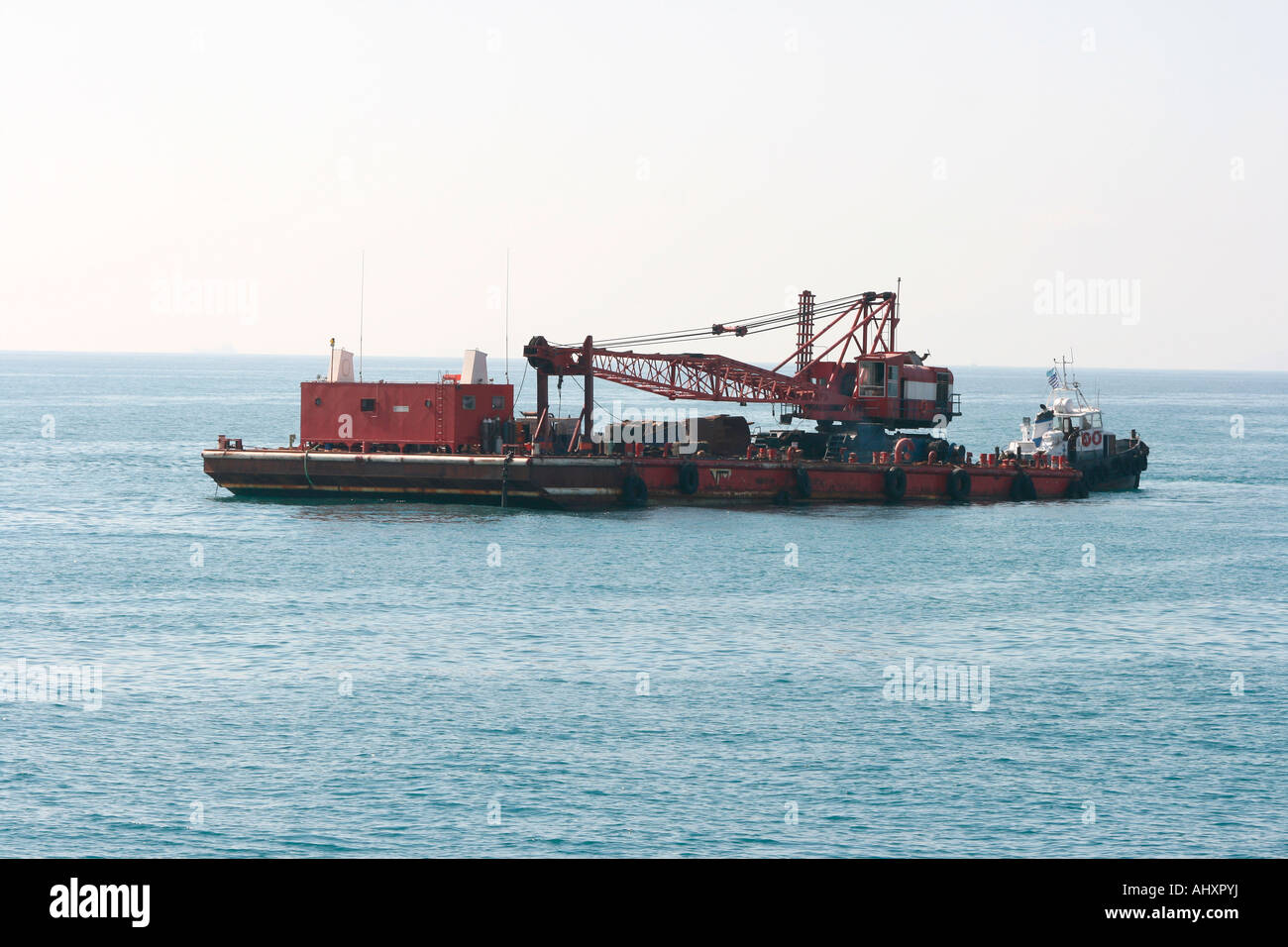 floating cargo sea crane and tugboat as tender Stock Photo - Alamy