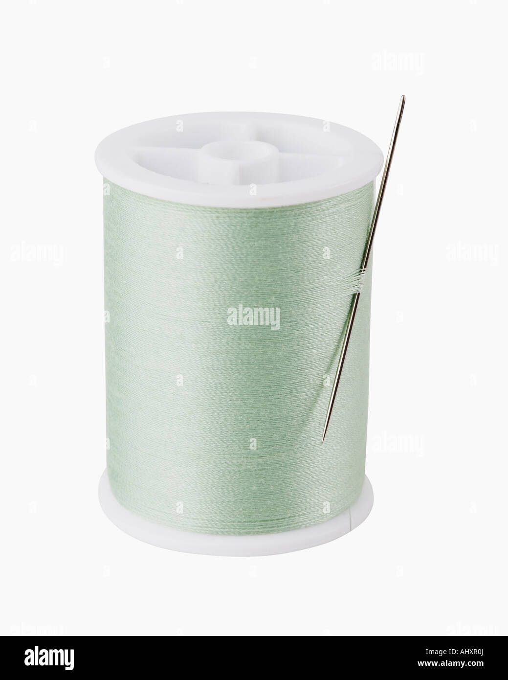 Close up of needle on spool of thread Stock Photo - Alamy