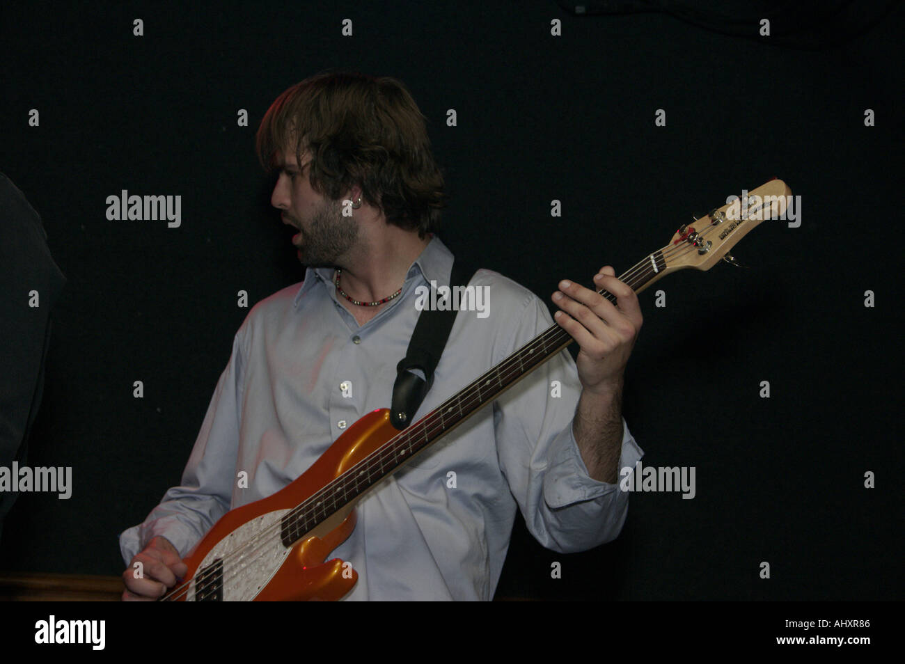 Guy in a rock band playing in a club Stock Photo - Alamy