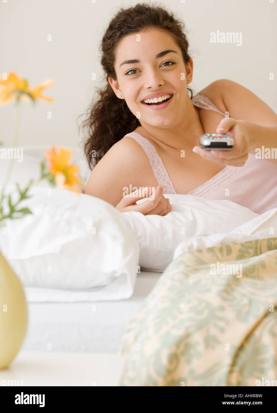 Woman pointing remote control Stock Photo - Alamy