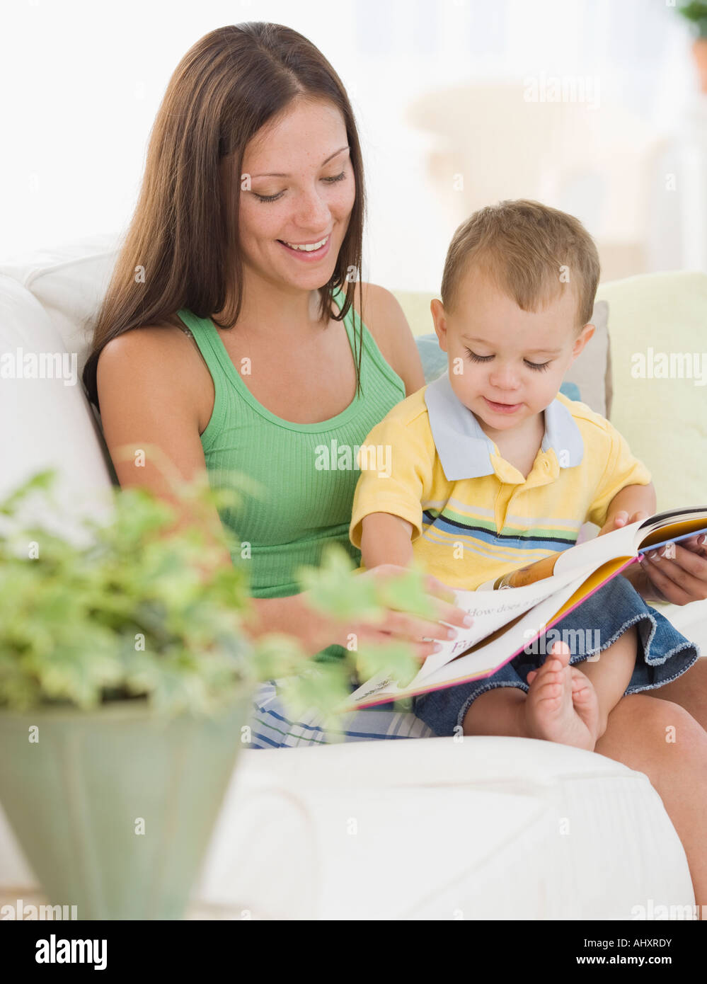 Mother reading to baby Stock Photo - Alamy