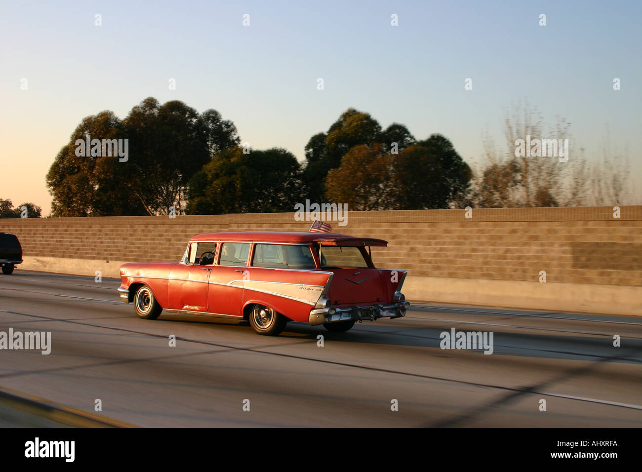 Man in a vintage red car driving on the highway Stock Photo - Alamy