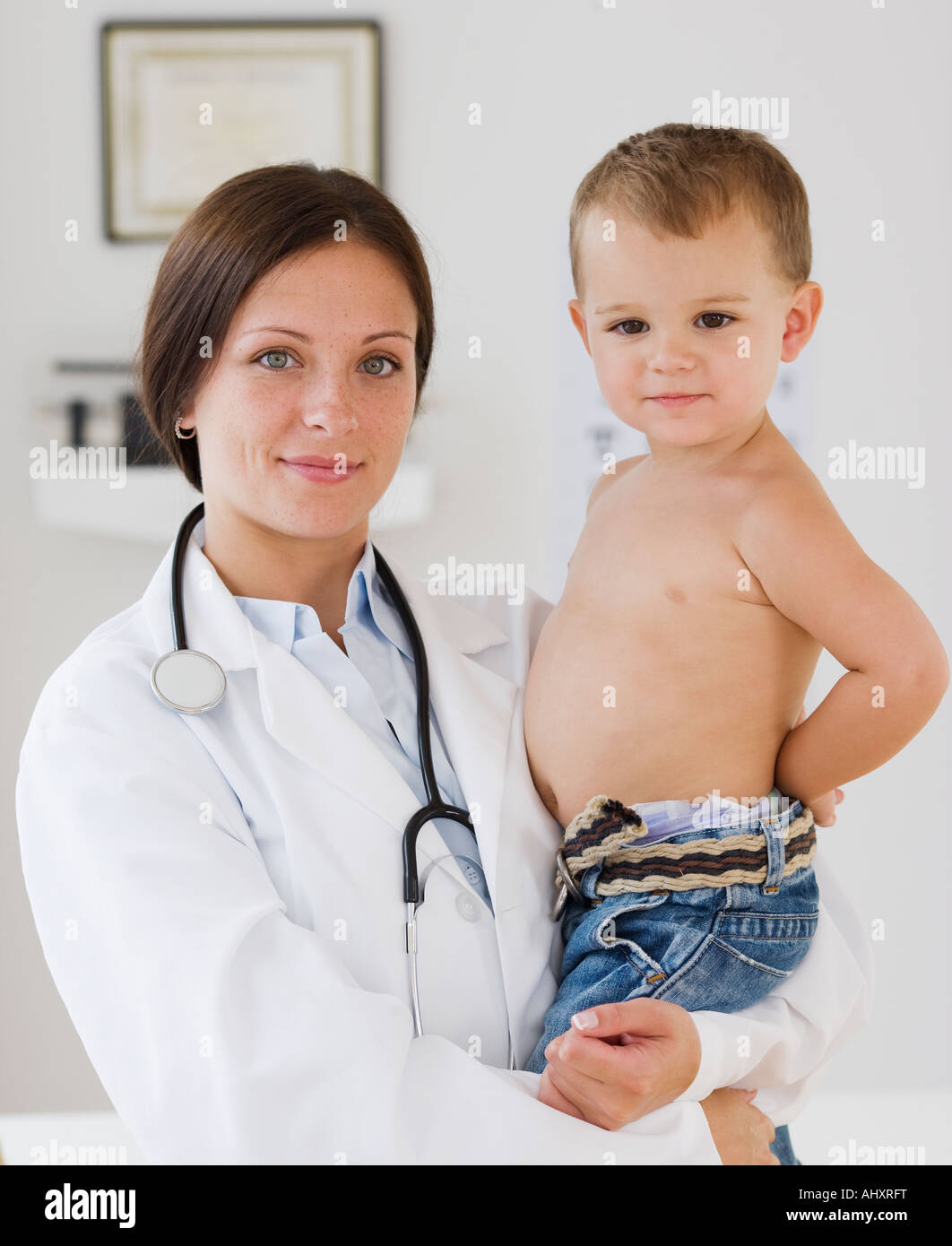 Female doctor holding baby Stock Photo - Alamy