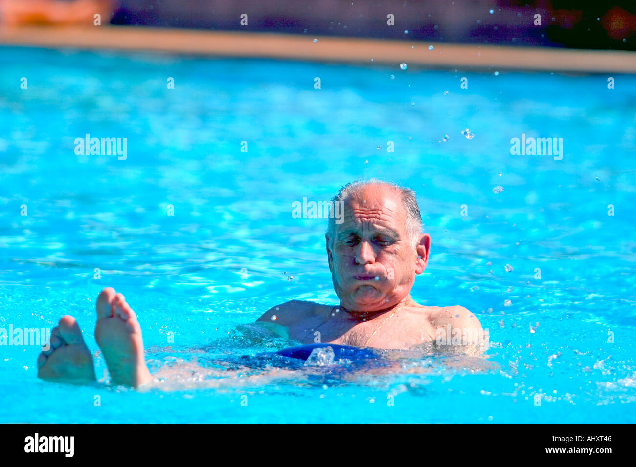 a single alone old man swimming in a private pool Stock Photo - Alamy