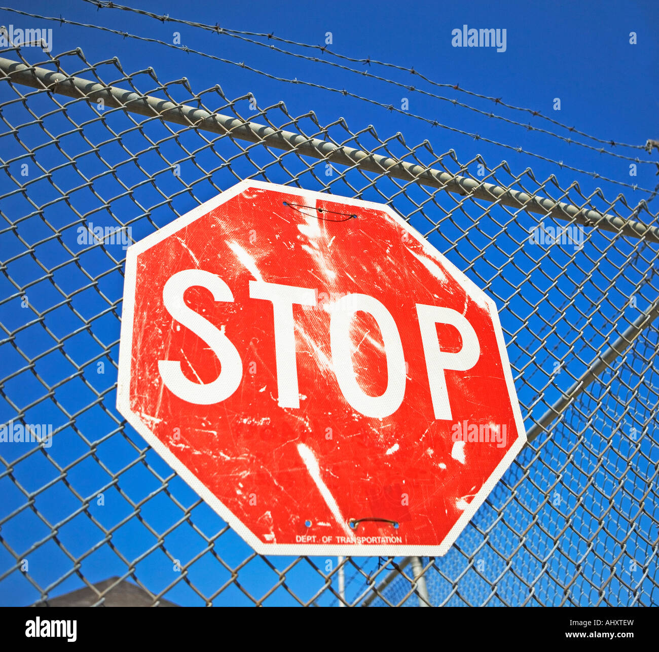 Stop sign on fence Stock Photo - Alamy