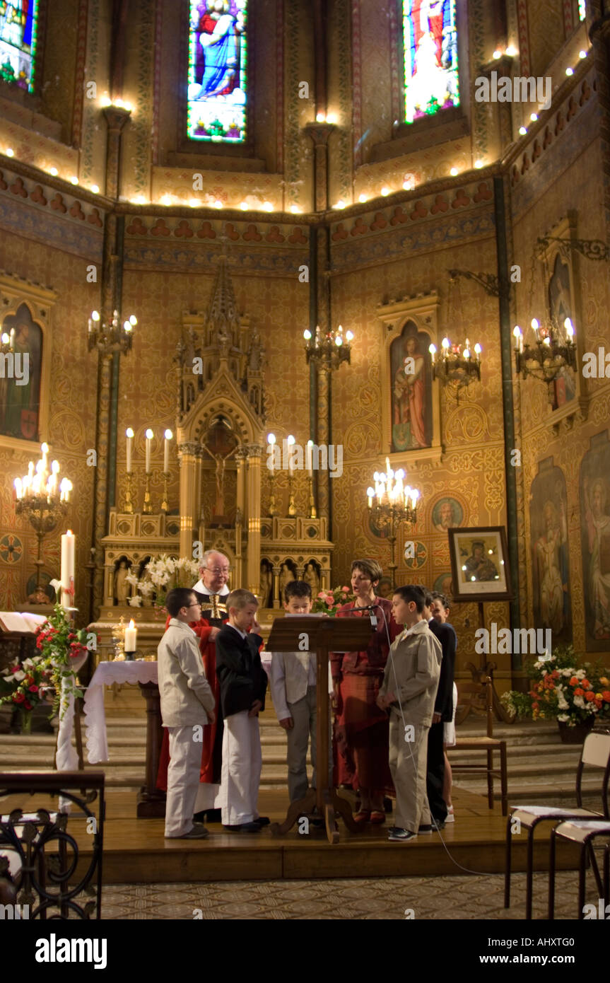 Children making vows during ceremony of first communion in catholic ...