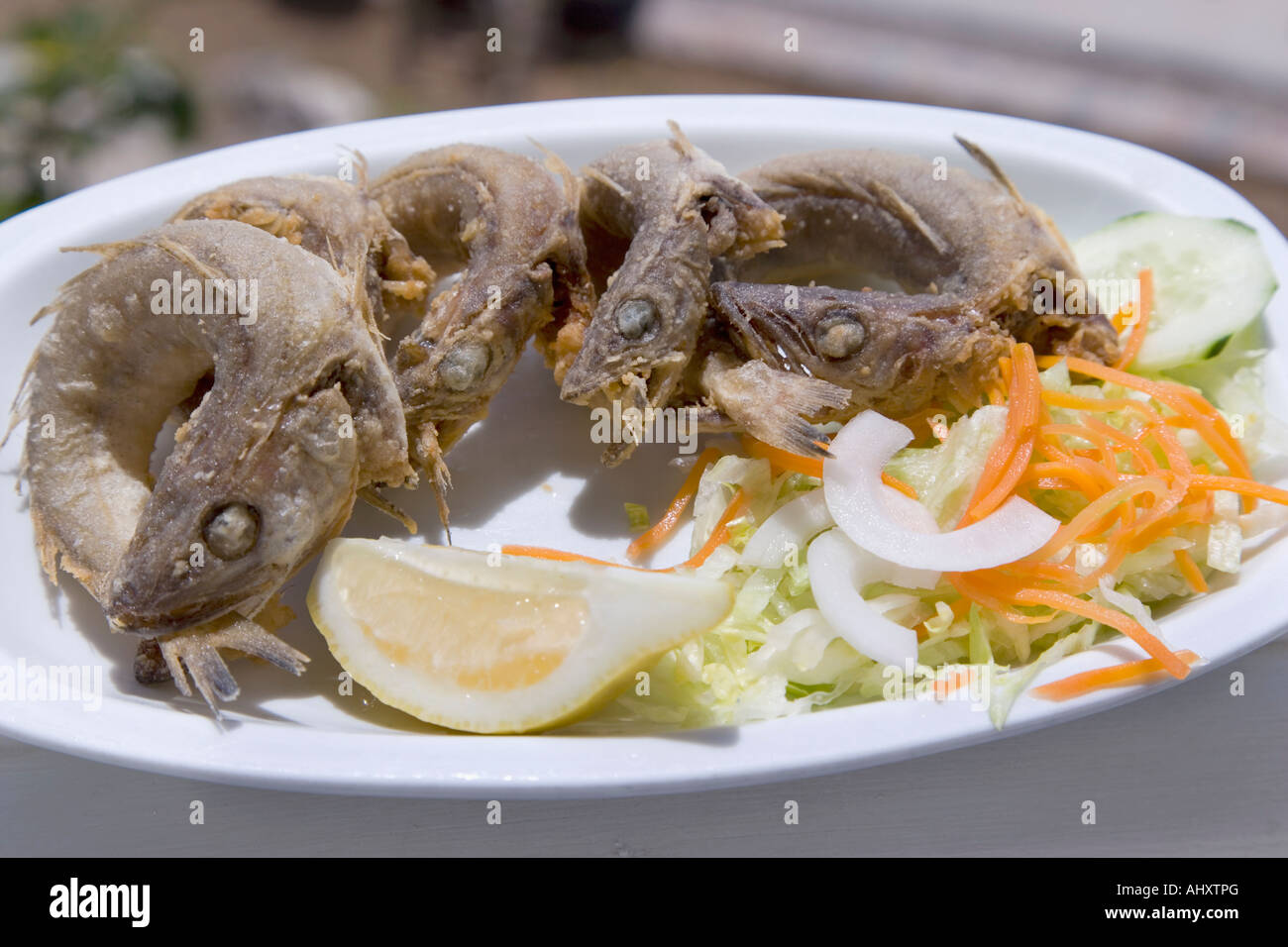 Spanish dish of pescaitos fritos con ensalada Fried little fish with ...