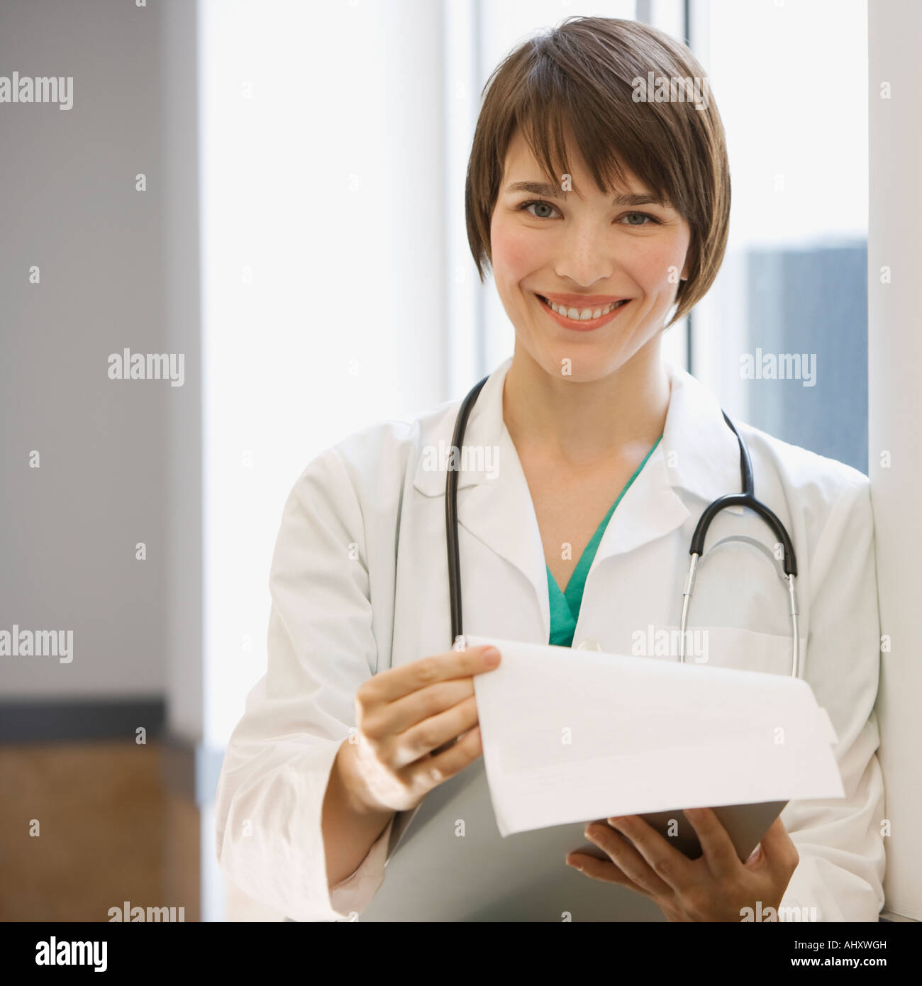 Female doctor holding chart Stock Photo - Alamy