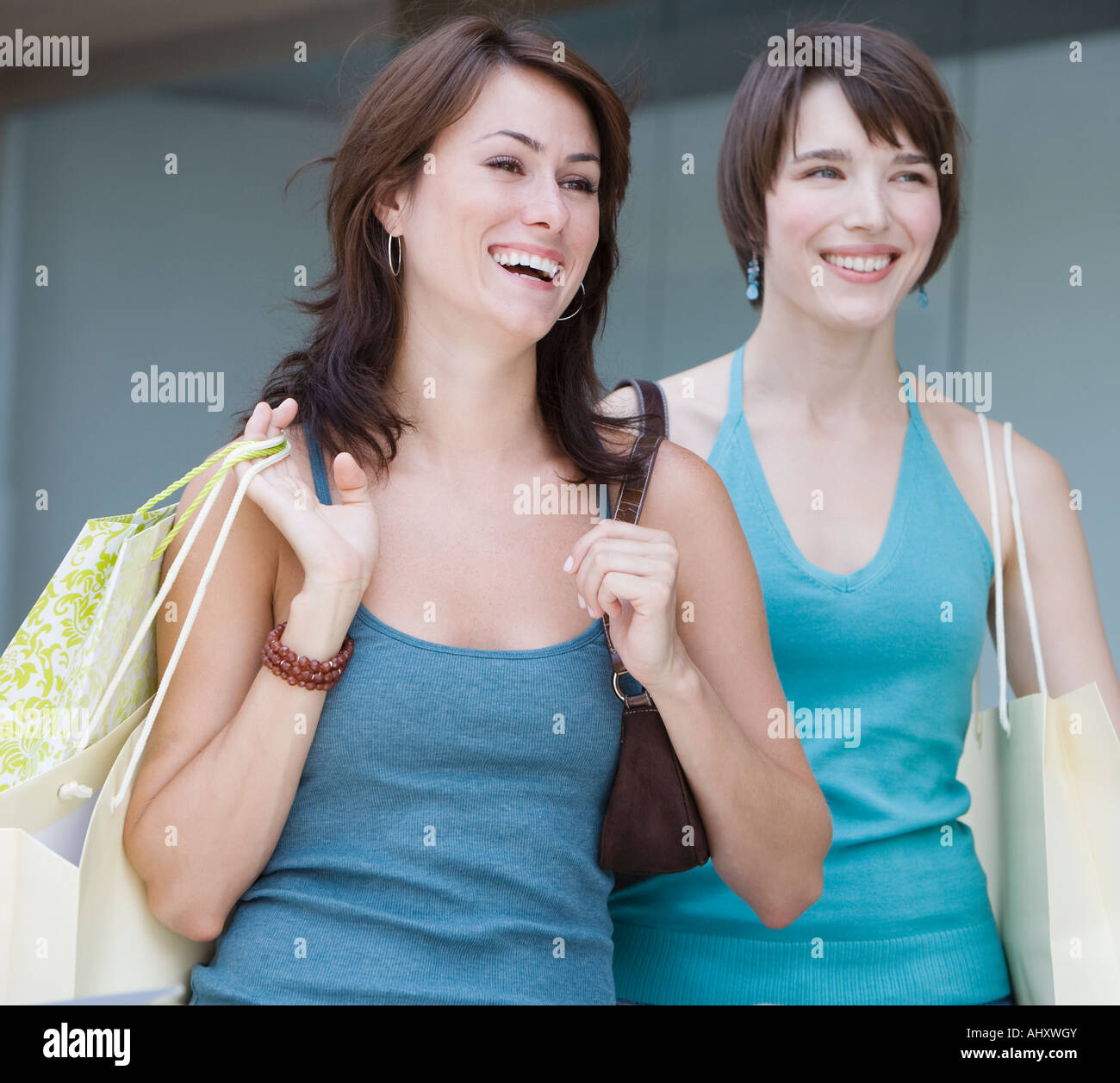 Two women carrying shopping bags Stock Photo - Alamy