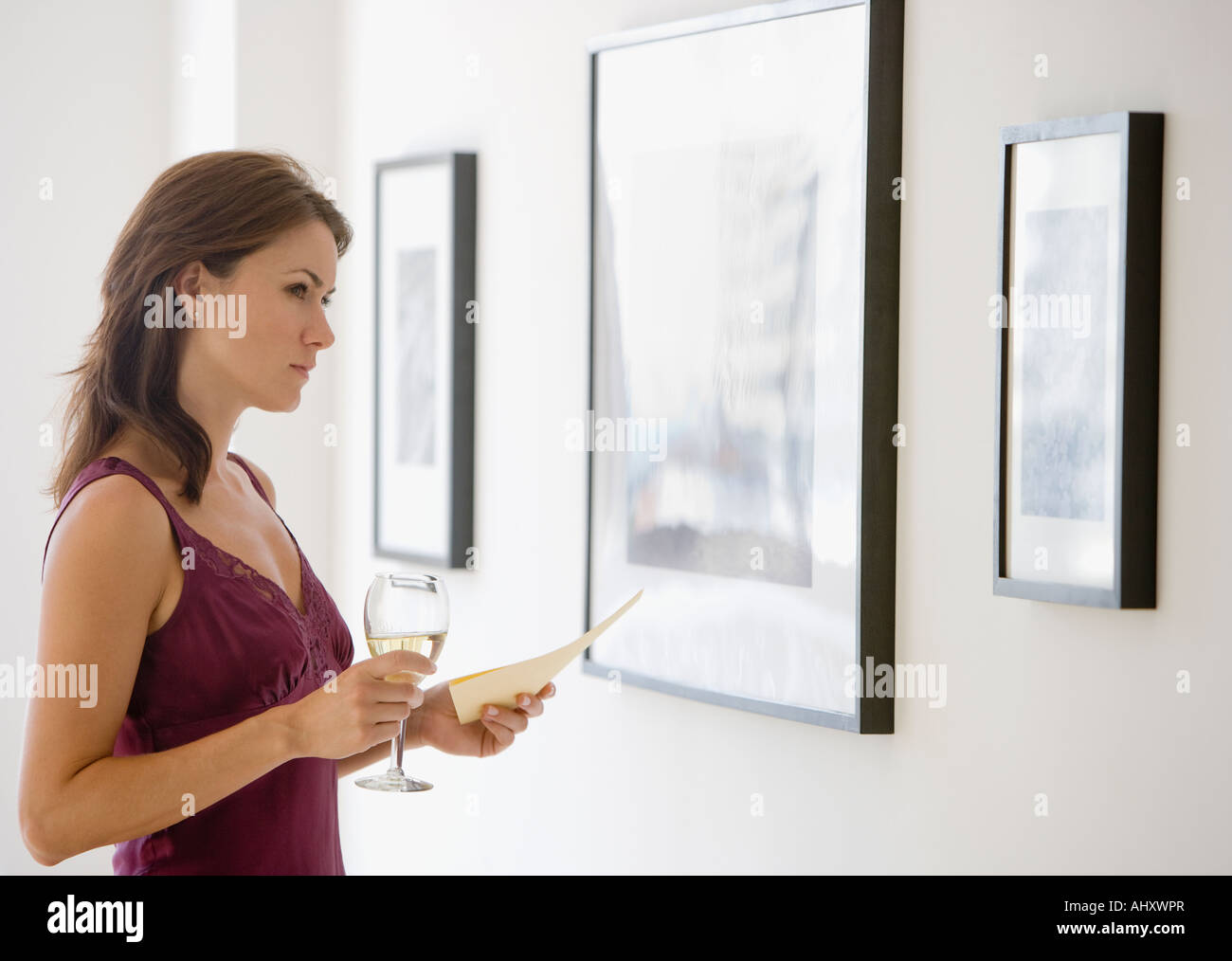 Woman looking at artwork in gallery Stock Photo - Alamy