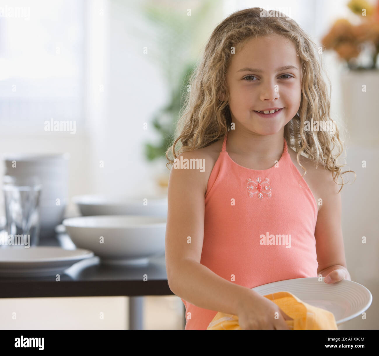 Girl drying off dish Stock Photo - Alamy