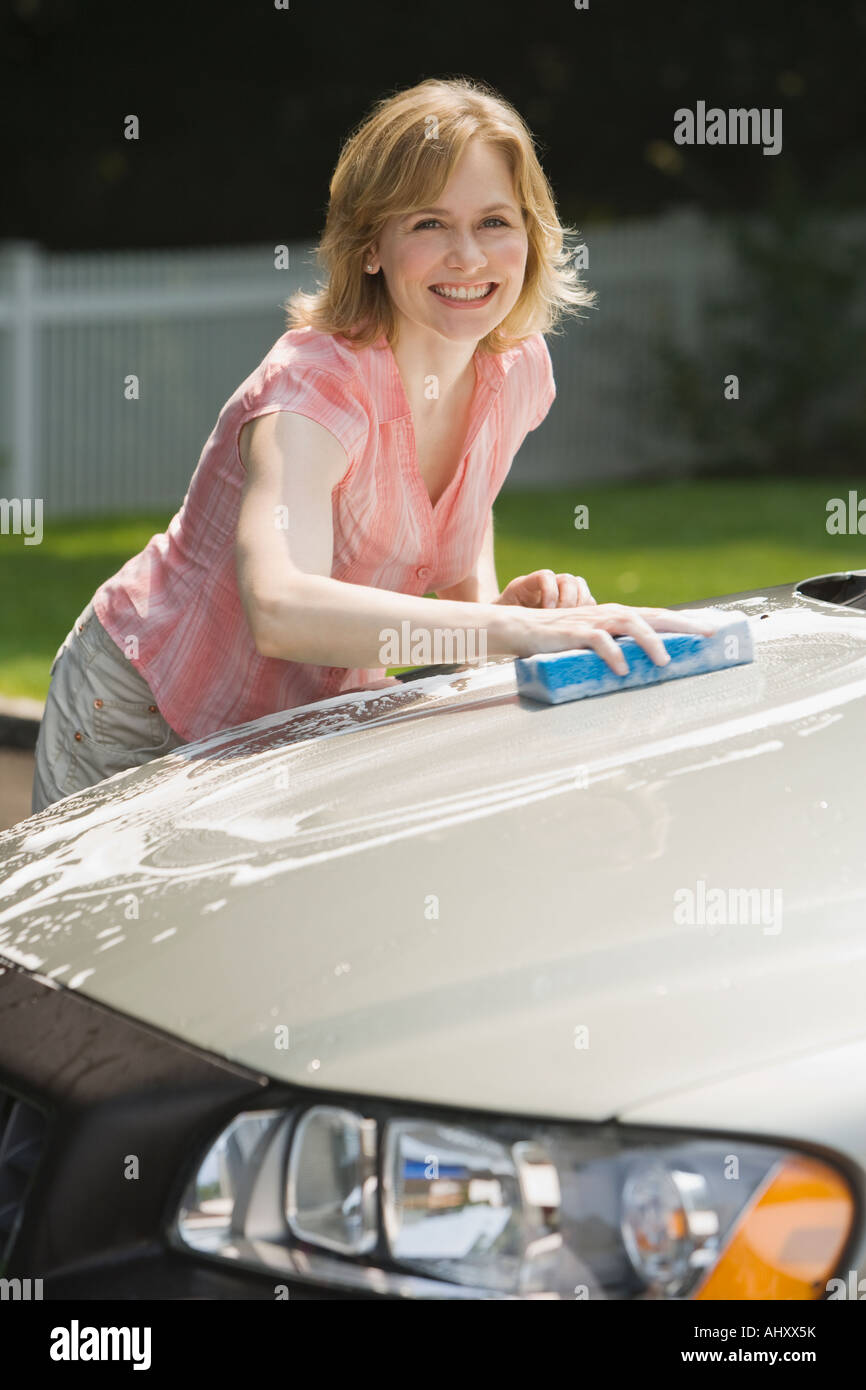 Woman washing car Stock Photo - Alamy