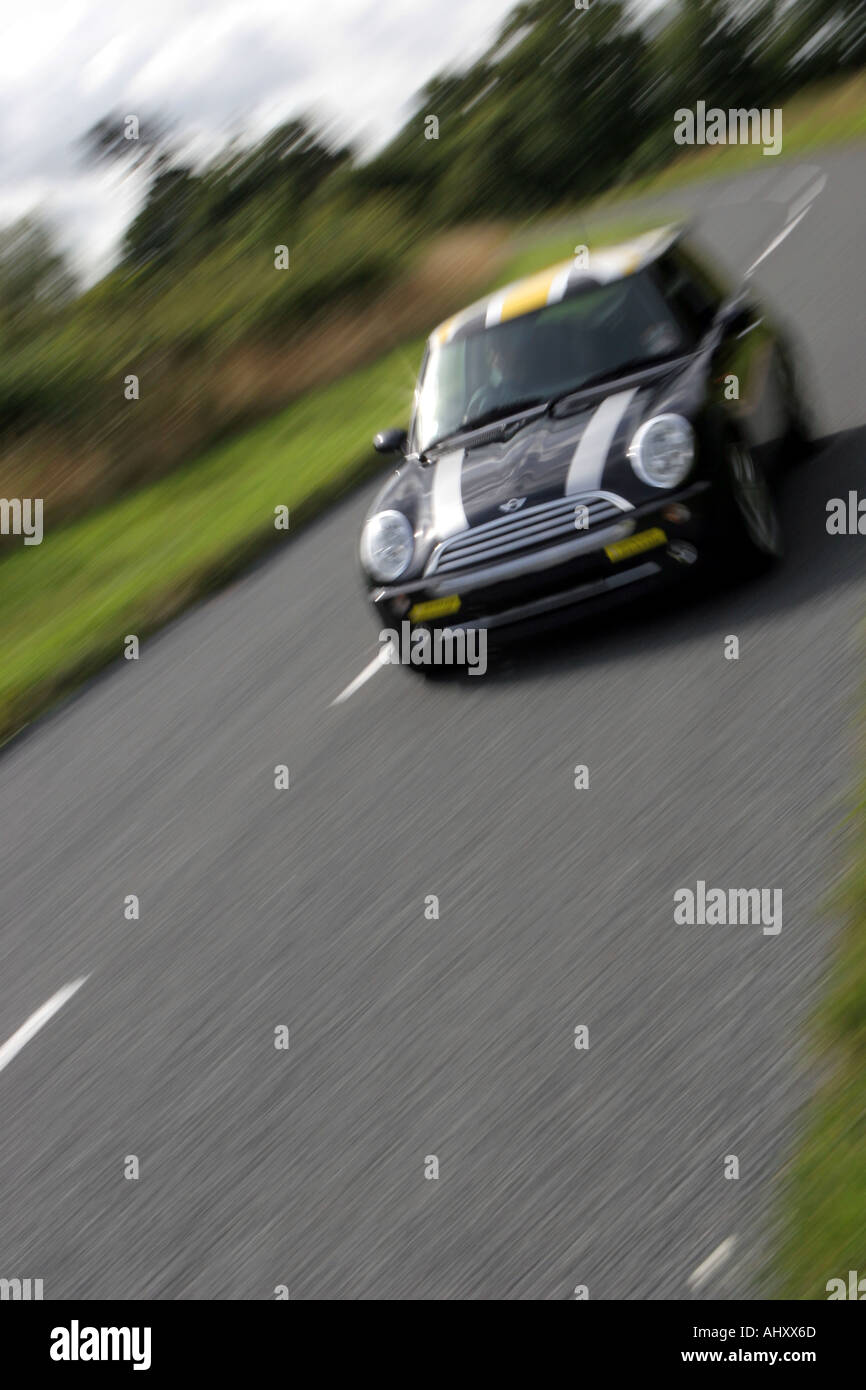 Speeding Mini Cooper on country lane Stock Photo - Alamy