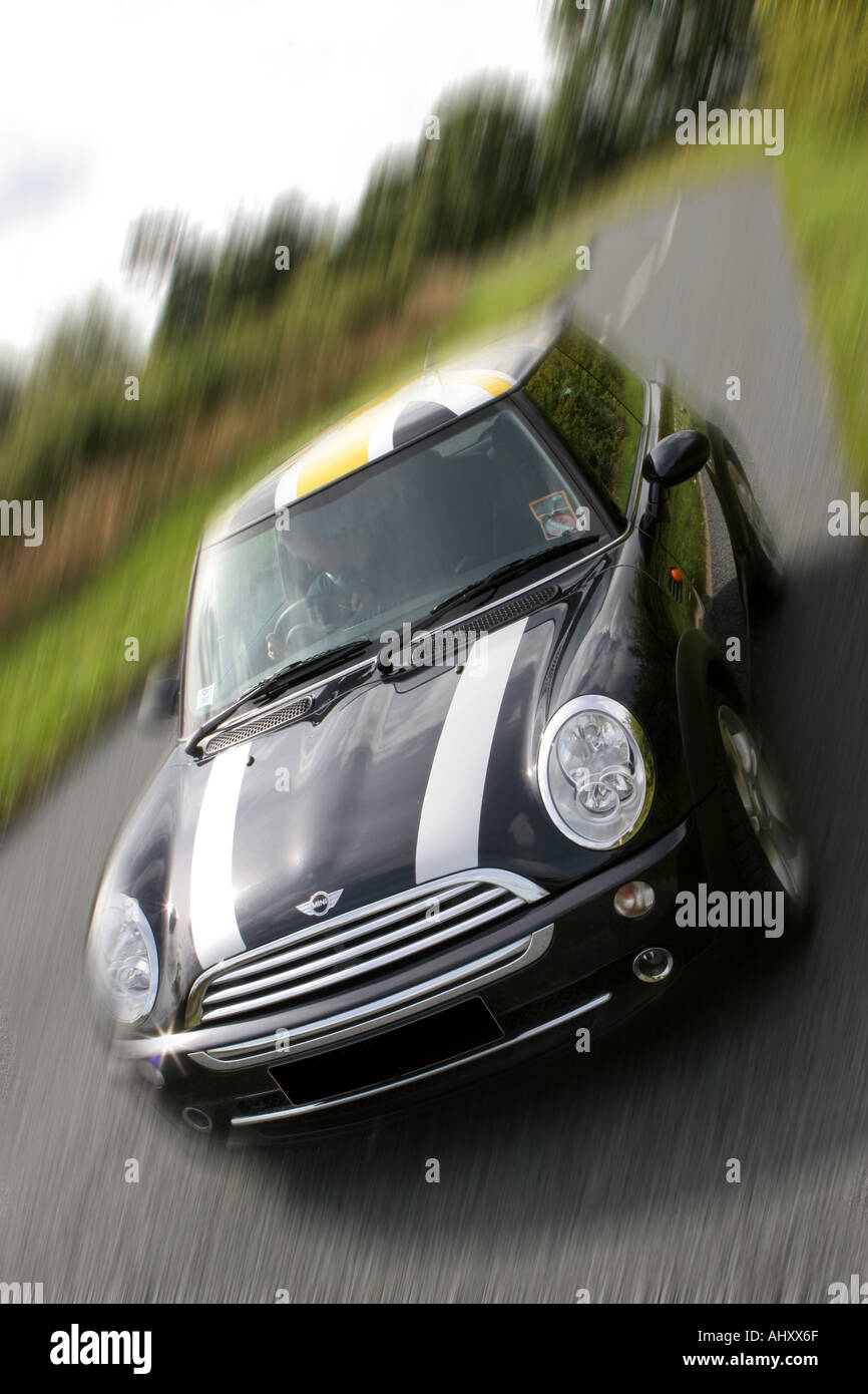 Speeding Mini Cooper on country lane Stock Photo - Alamy