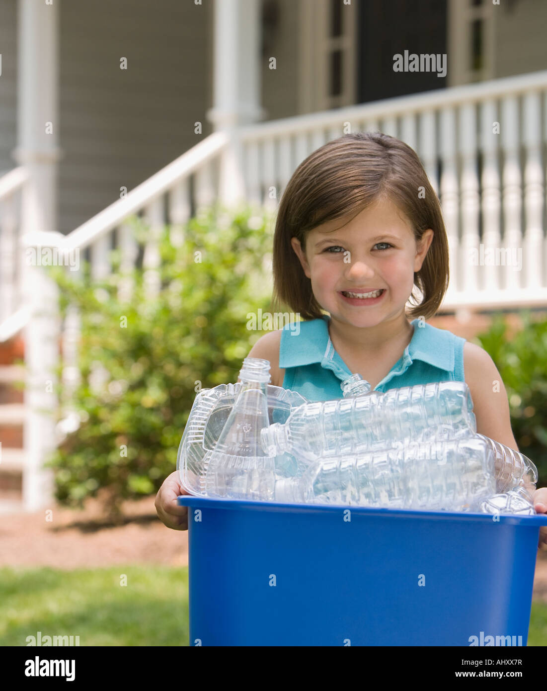 Girl carrying recycling bin Stock Photo - Alamy