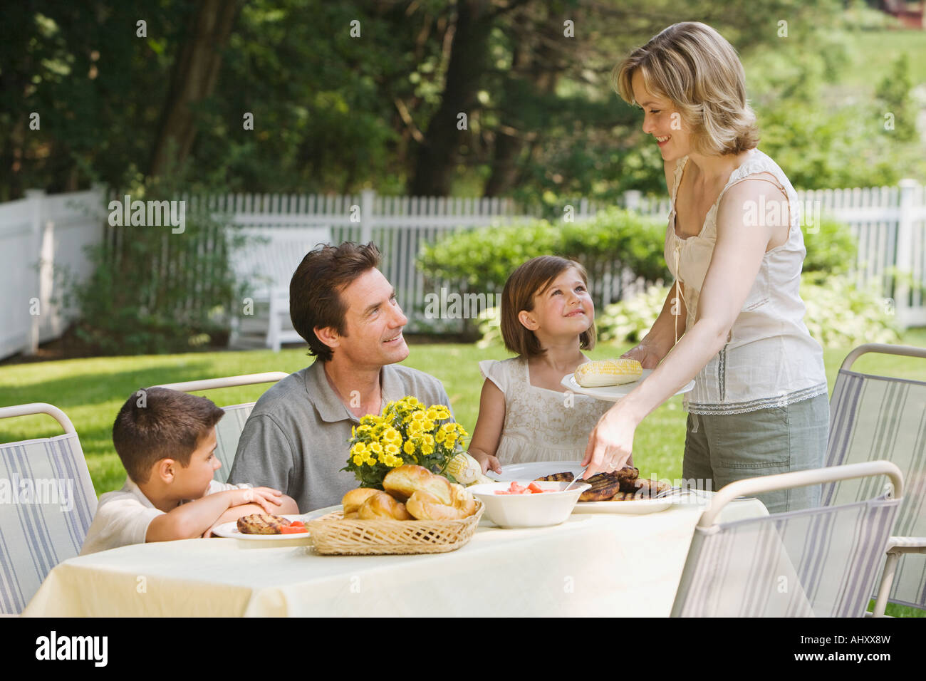 Three women seated outside eating food hi-res stock photography and ...