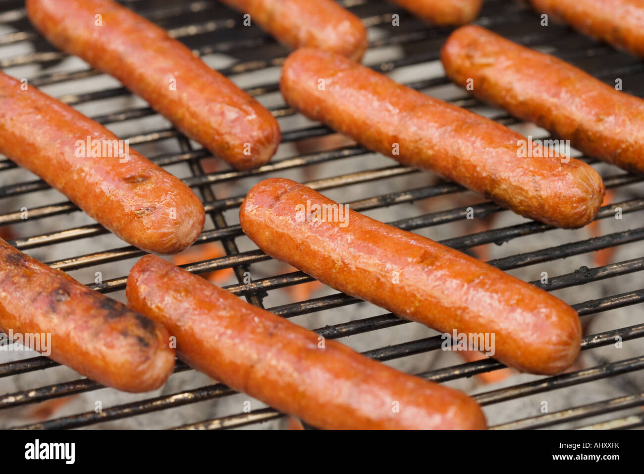 Hot dogs cooking on grill Stock Photo - Alamy