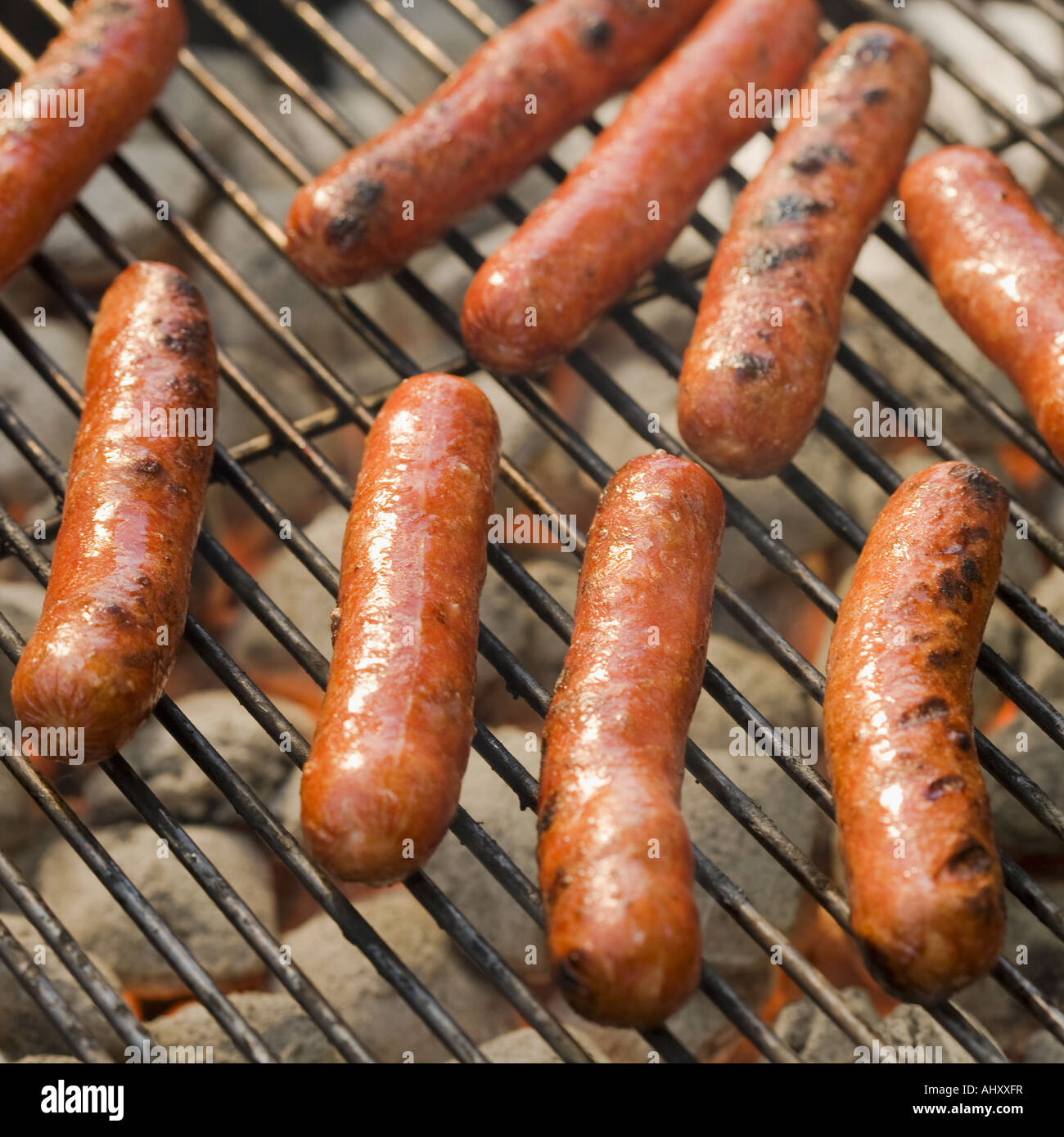 Hot dogs cooking on grill Stock Photo - Alamy