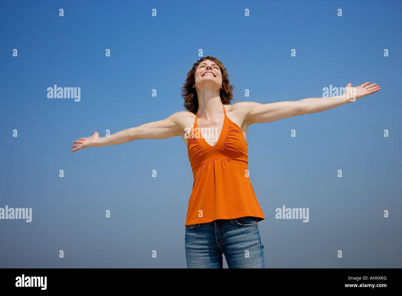 Woman with arms outstretched Stock Photo - Alamy