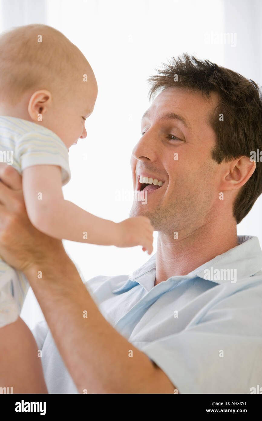 Father and baby smiling at each other Stock Photo - Alamy